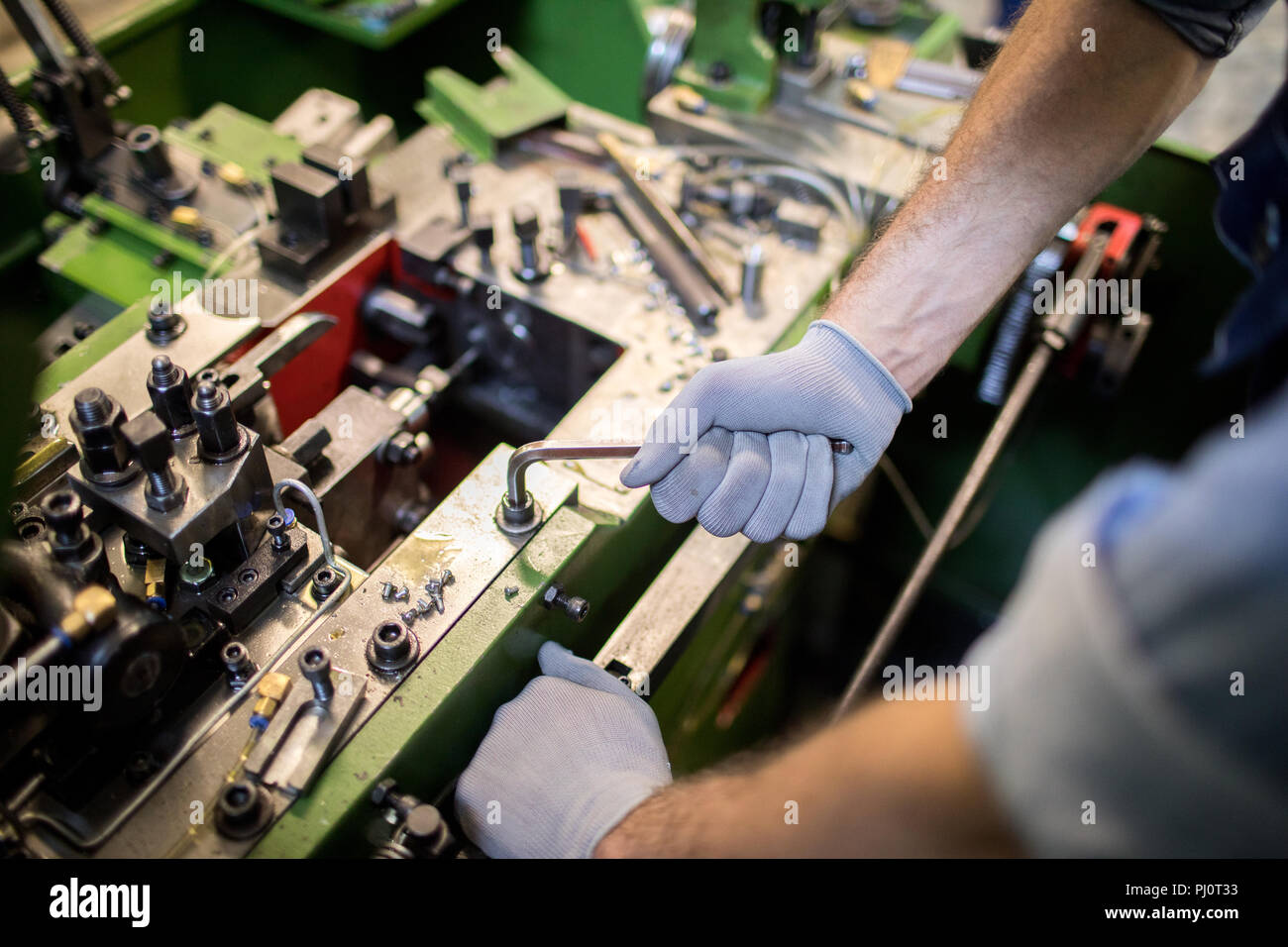 Worker turning on industrial machine hi-res stock photography and ...