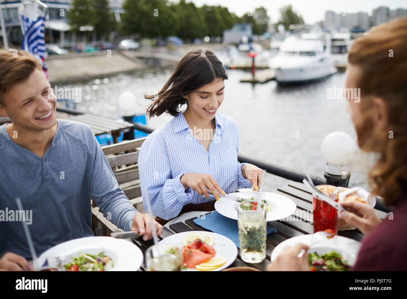 Friends talking by lunch Stock Photo - Alamy
