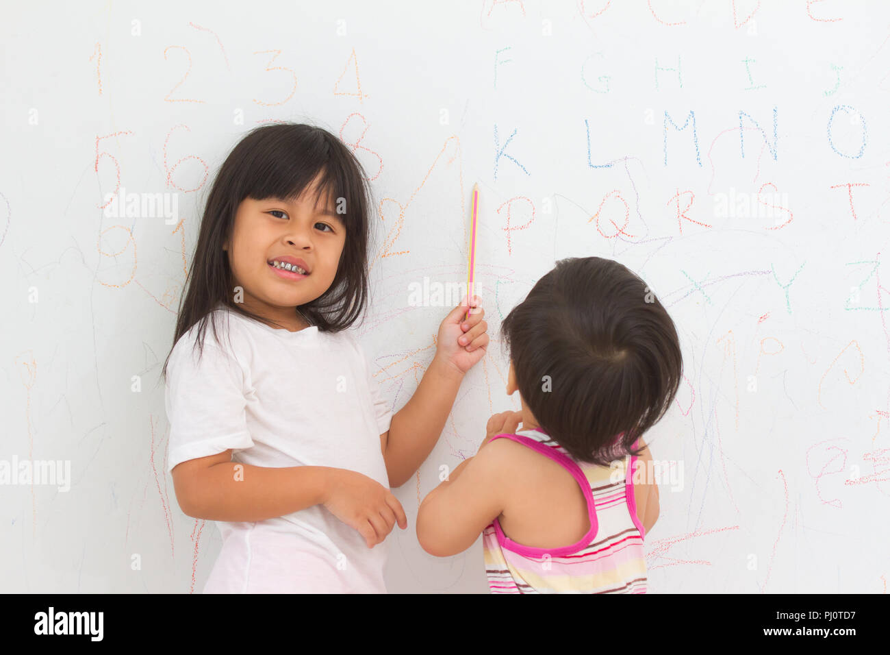 portrait of children writing on the wall Stock Photo - Alamy