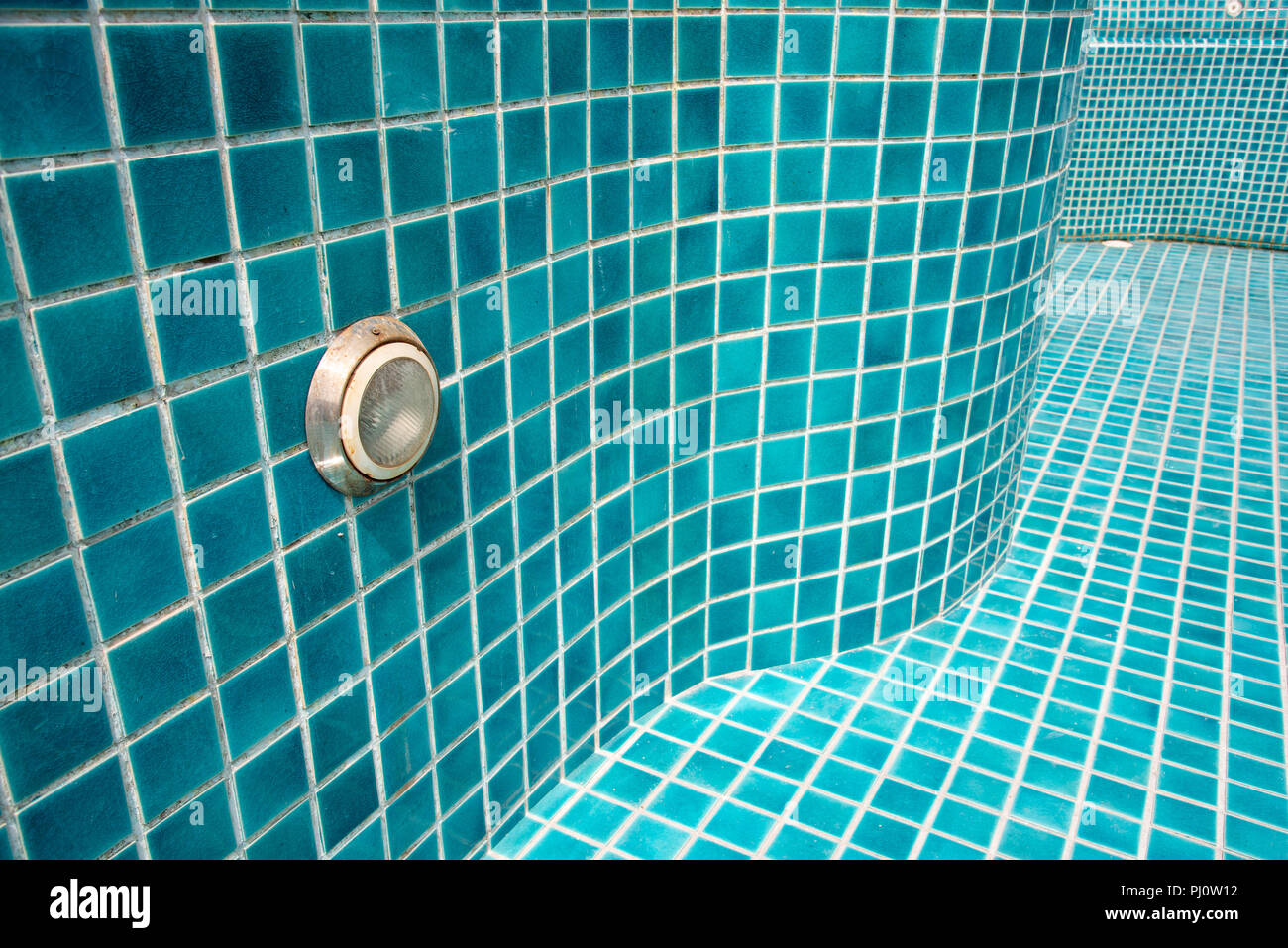 Close up of blue swimming pool tiled floor. Architect and construction ...
