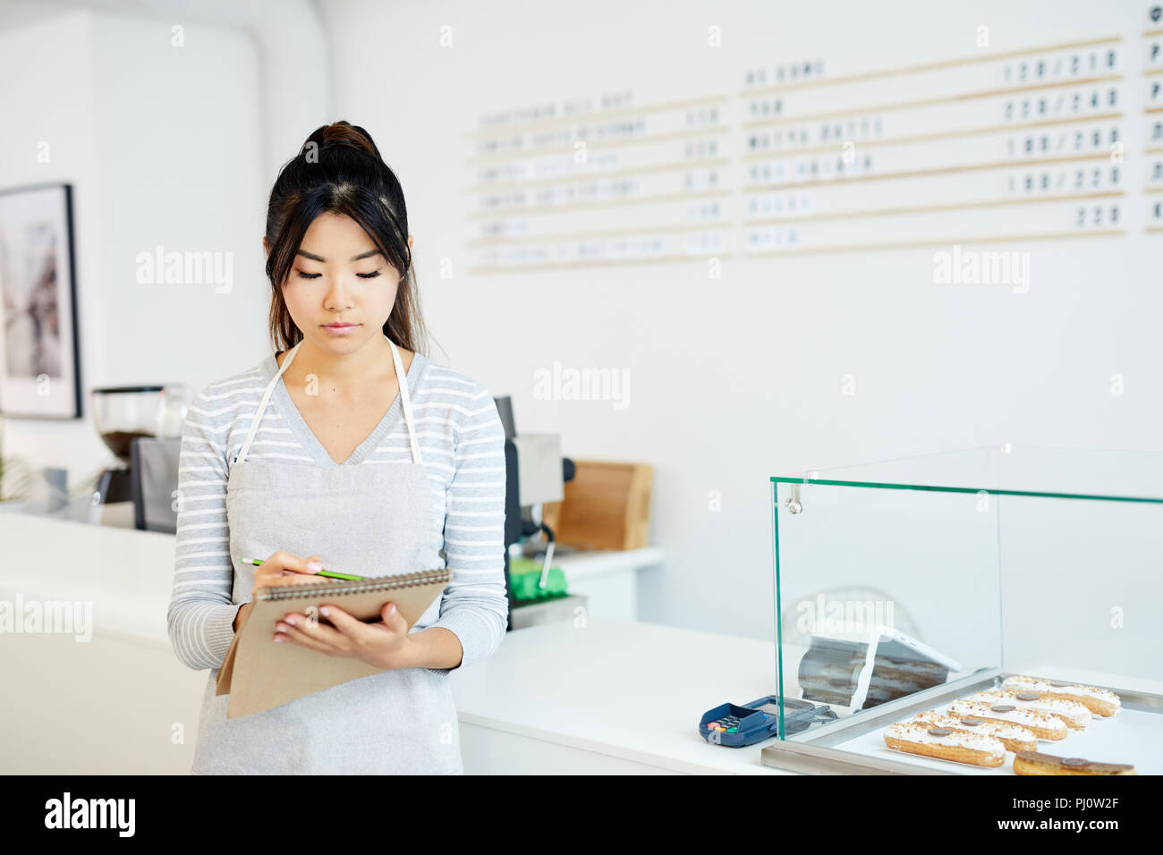 Waitress by counter Stock Photo - Alamy