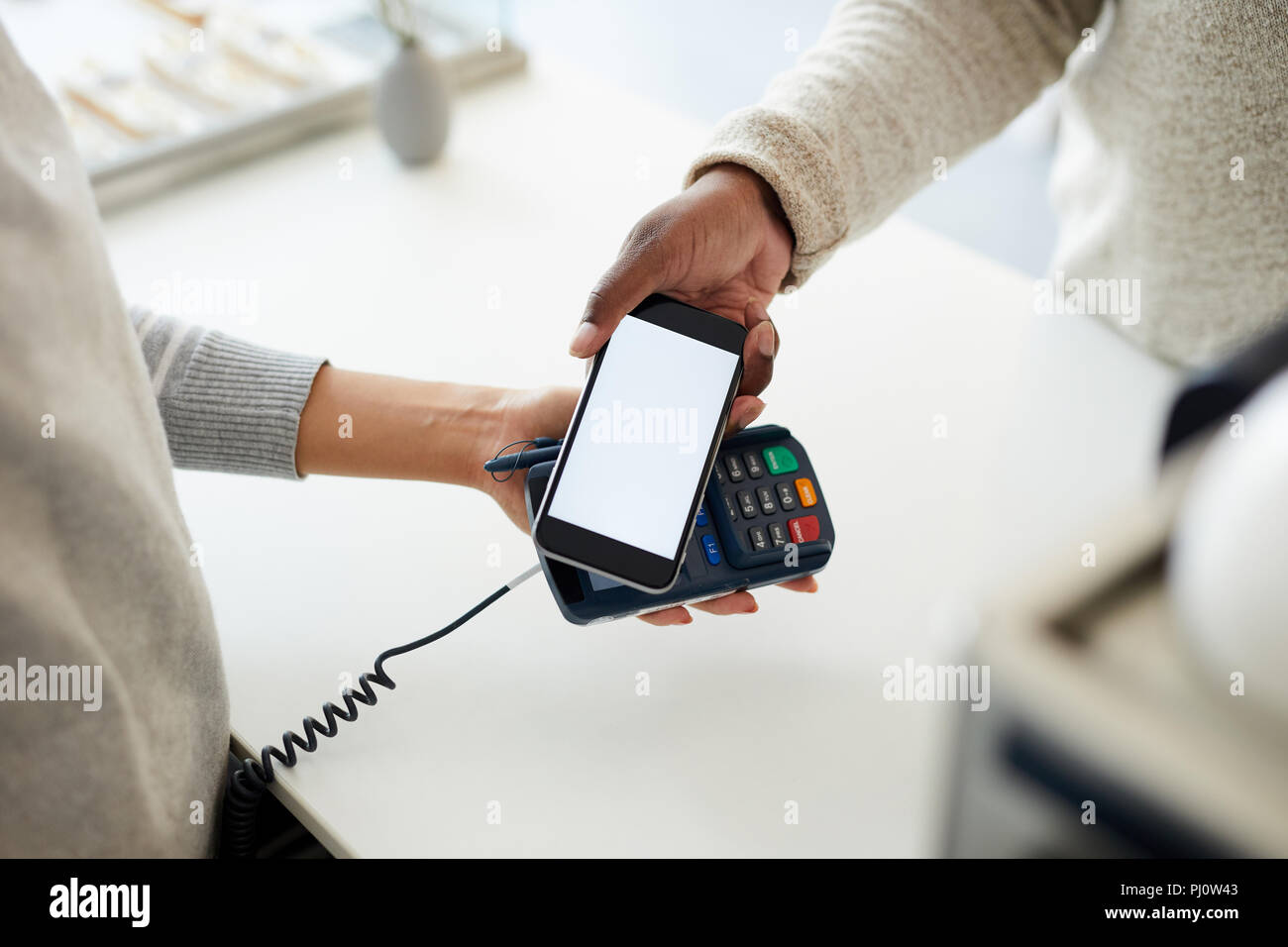 Paying by smartphone Stock Photo - Alamy