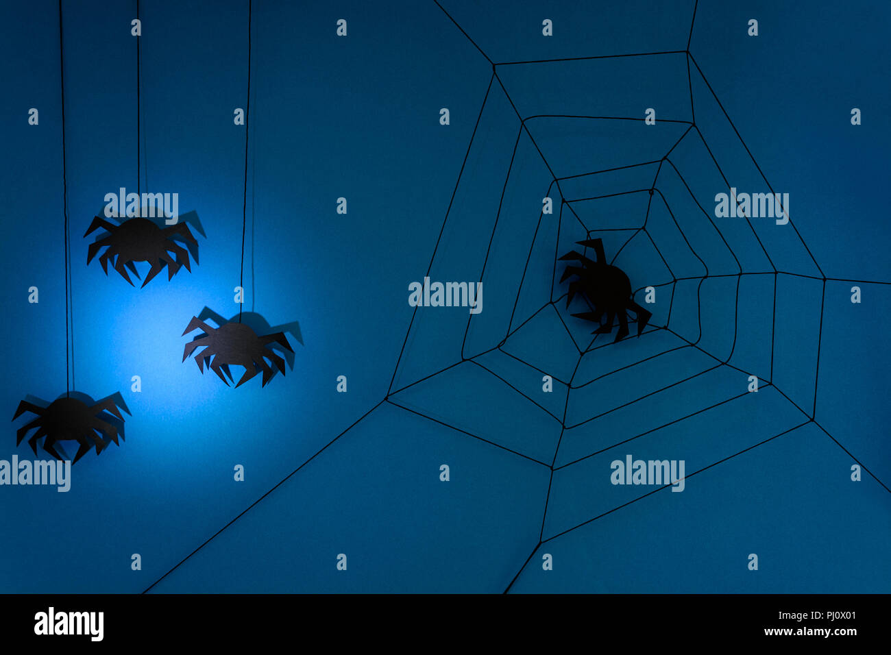 Black paper spider with web on dark blue background. Halloween concept ...