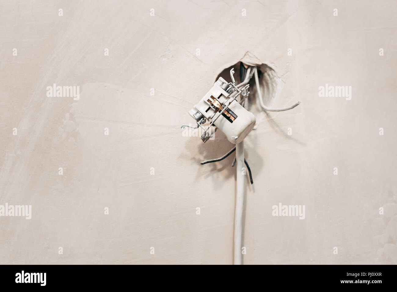 Dangerous open socket with protruding wires in wall. Safety concept ...