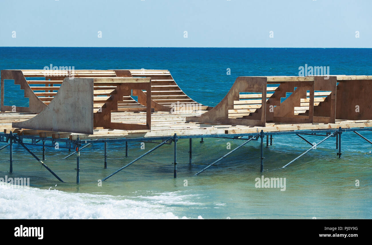 Construction process of summer skatepark. Wooden mini ramp being built ...