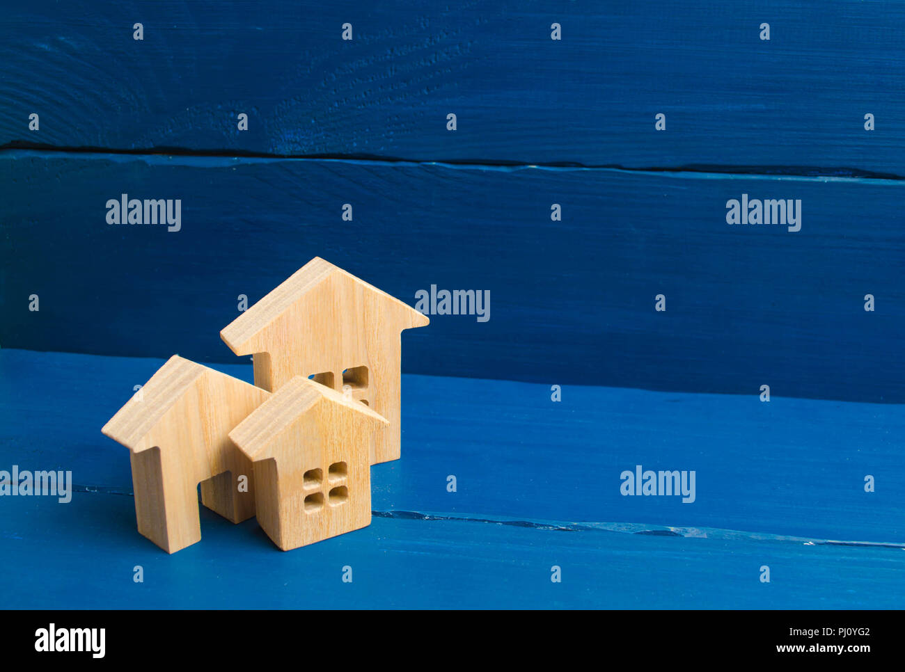 Buying and selling of real estate, construction. Three houses on a blue ...