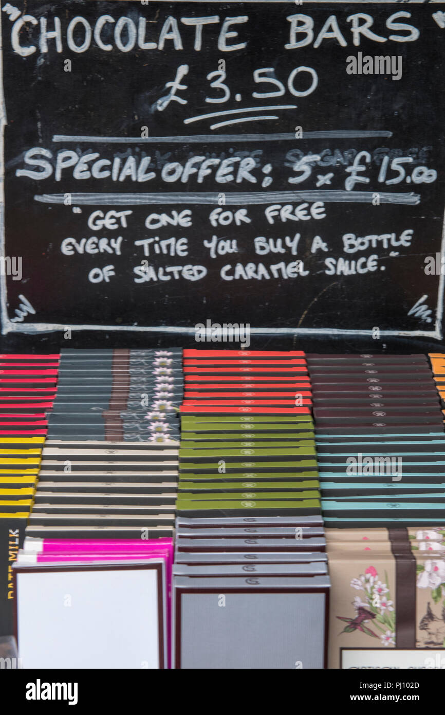 a colourful selection of chocolate bars on display at a confectioners ...