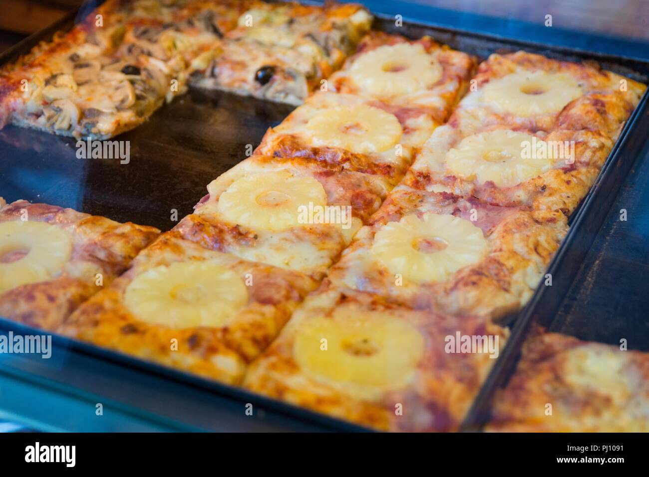 Italian pizza to go. Pizza in pieces. Take away food. Street food Stock ...