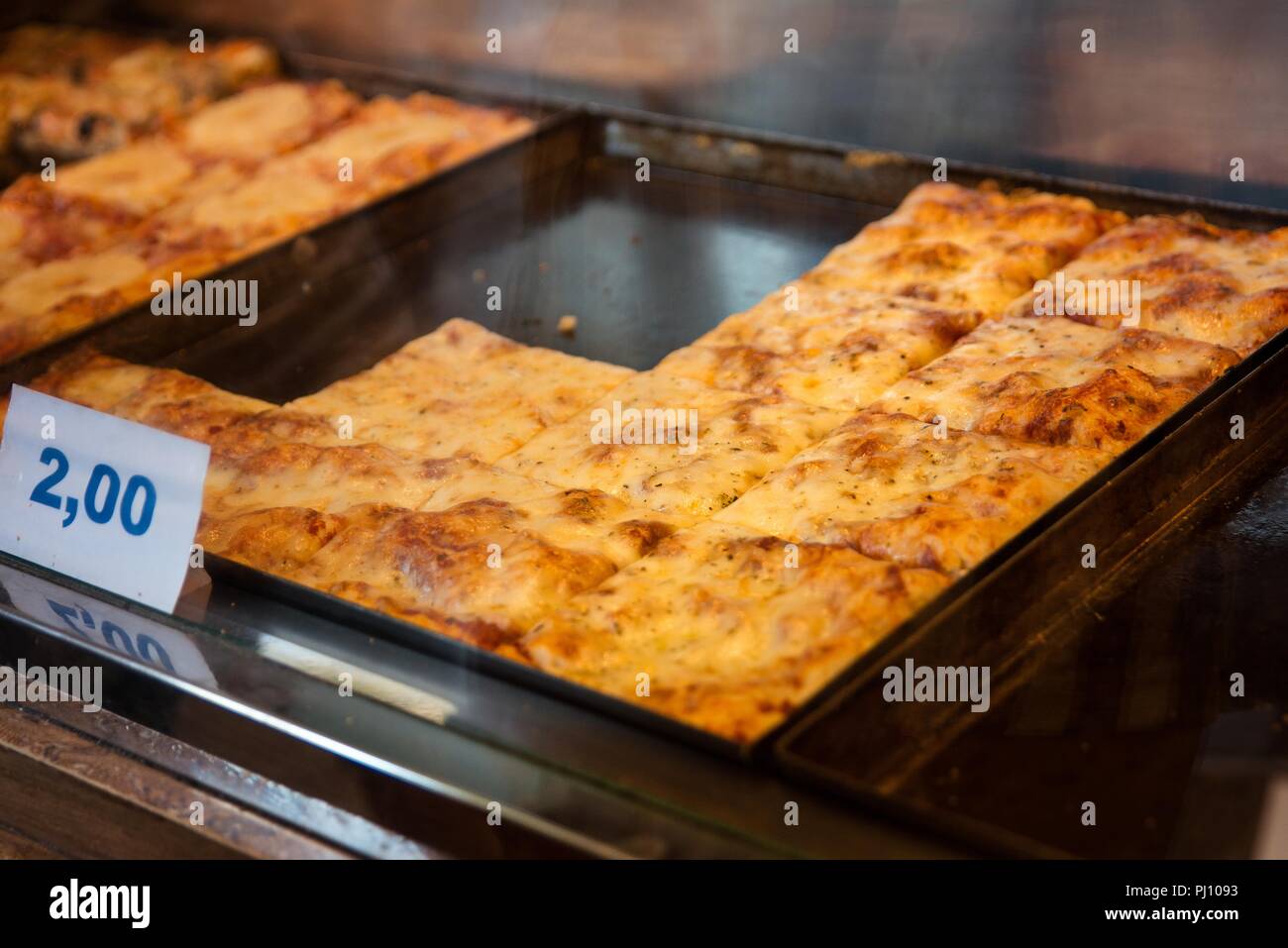 Italian pizza to go. Pizza in pieces. Take away food. Street food Stock ...