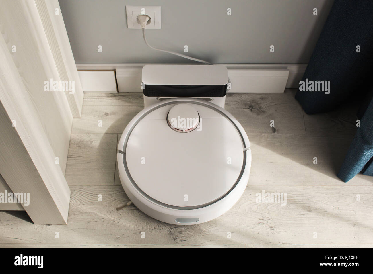 Robotic vacuum cleaner is charging at the preset point, technological ...
