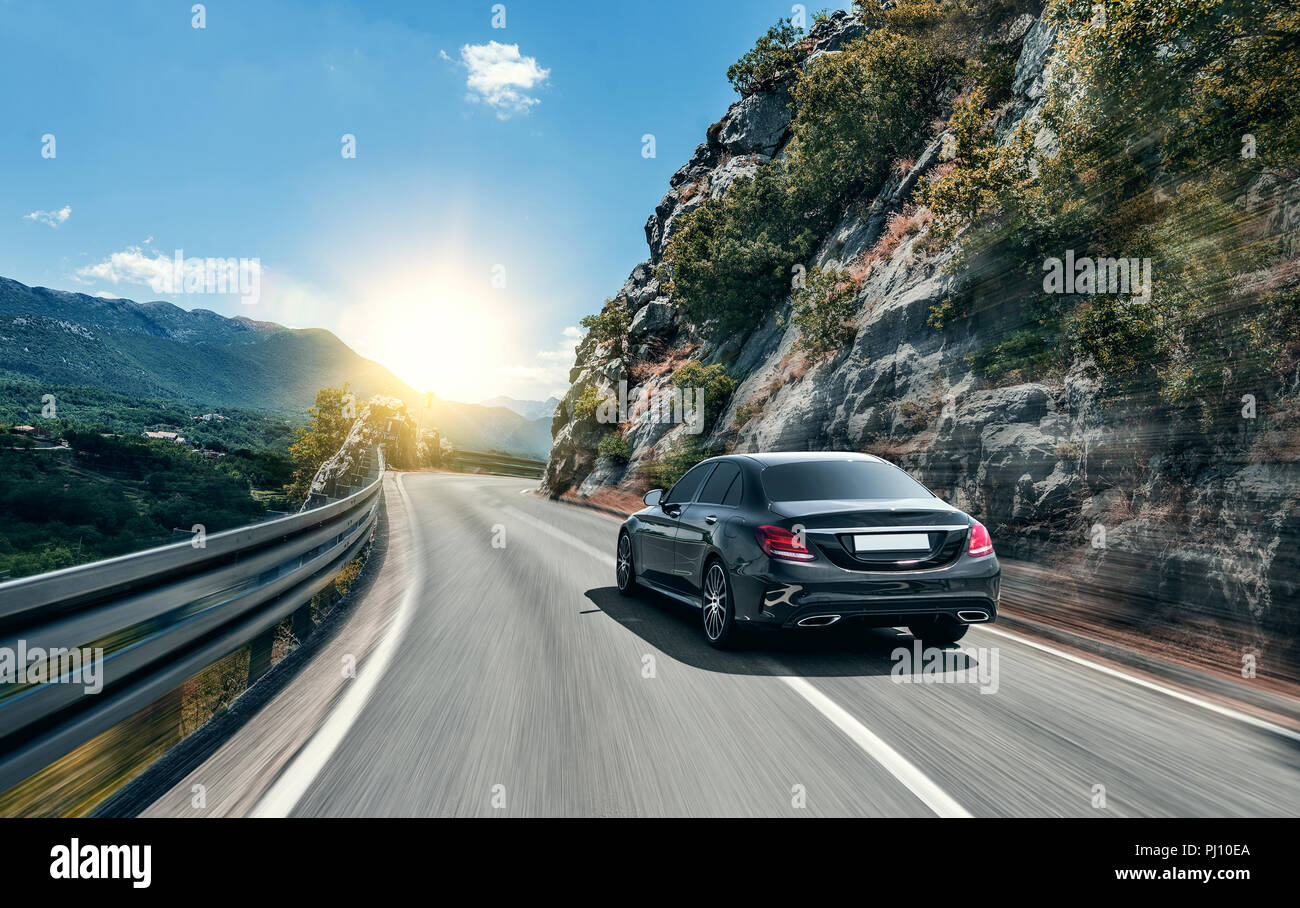 Black car rushing along a high-speed highway in the sun Stock Photo - Alamy