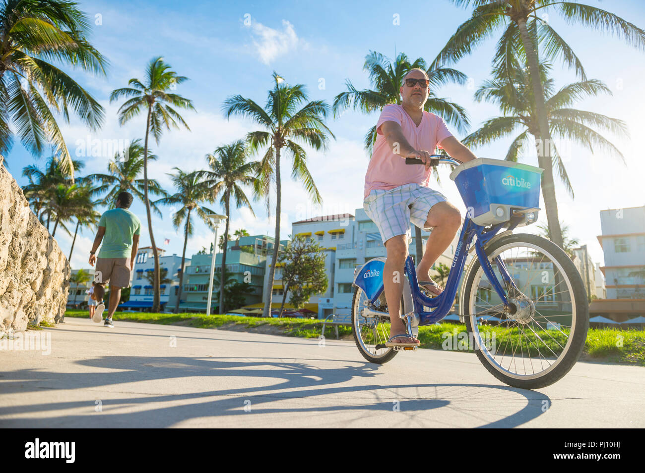 MIAMI - CIRCA JUNE 2017: Man rides a 'Citi Bike' bicycle share along ...