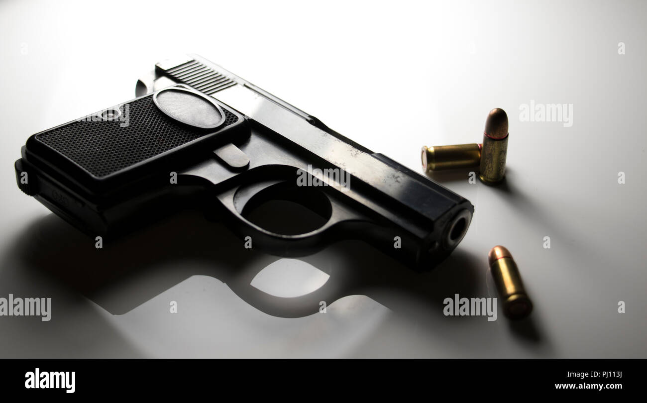 Hand gun with bullets isolated on white background Stock Photo - Alamy