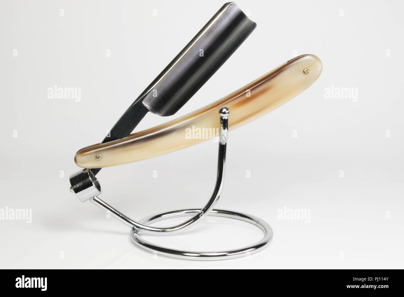 Straight Razor in stand isolated on a white background. Classic shaving ...