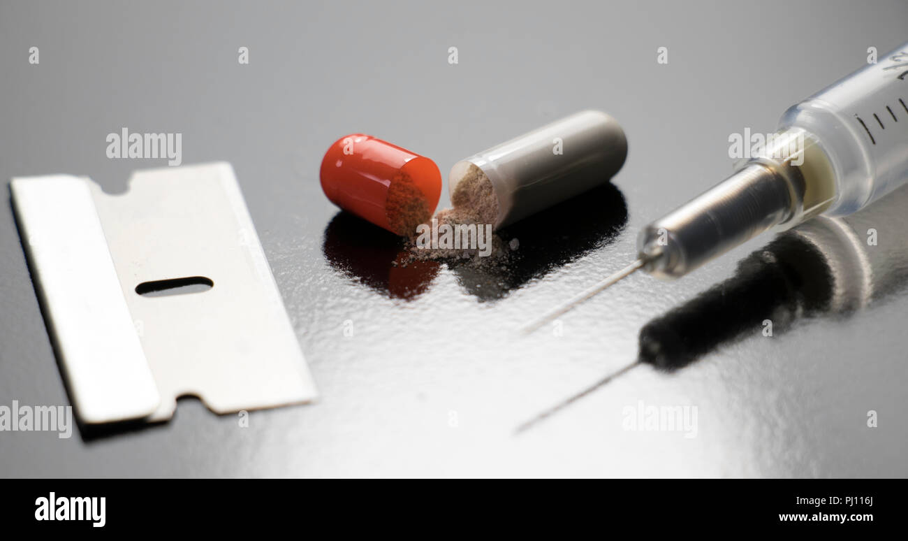 Razor, Needle and Pill Isolated on a black background. Objects from the ...