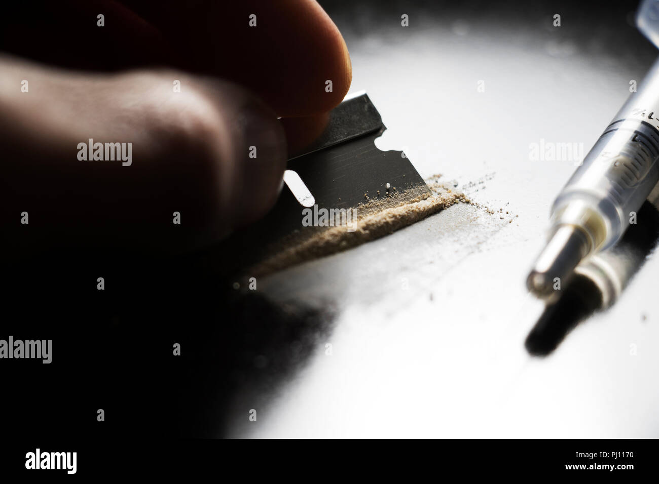 Illegal Drug use on the incline. Heroin and Cocaine razor and needle of ...