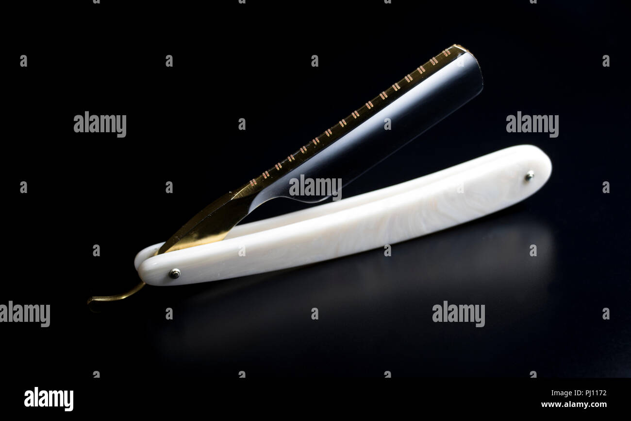 White and gold straight razor isolated on black background Stock Photo ...