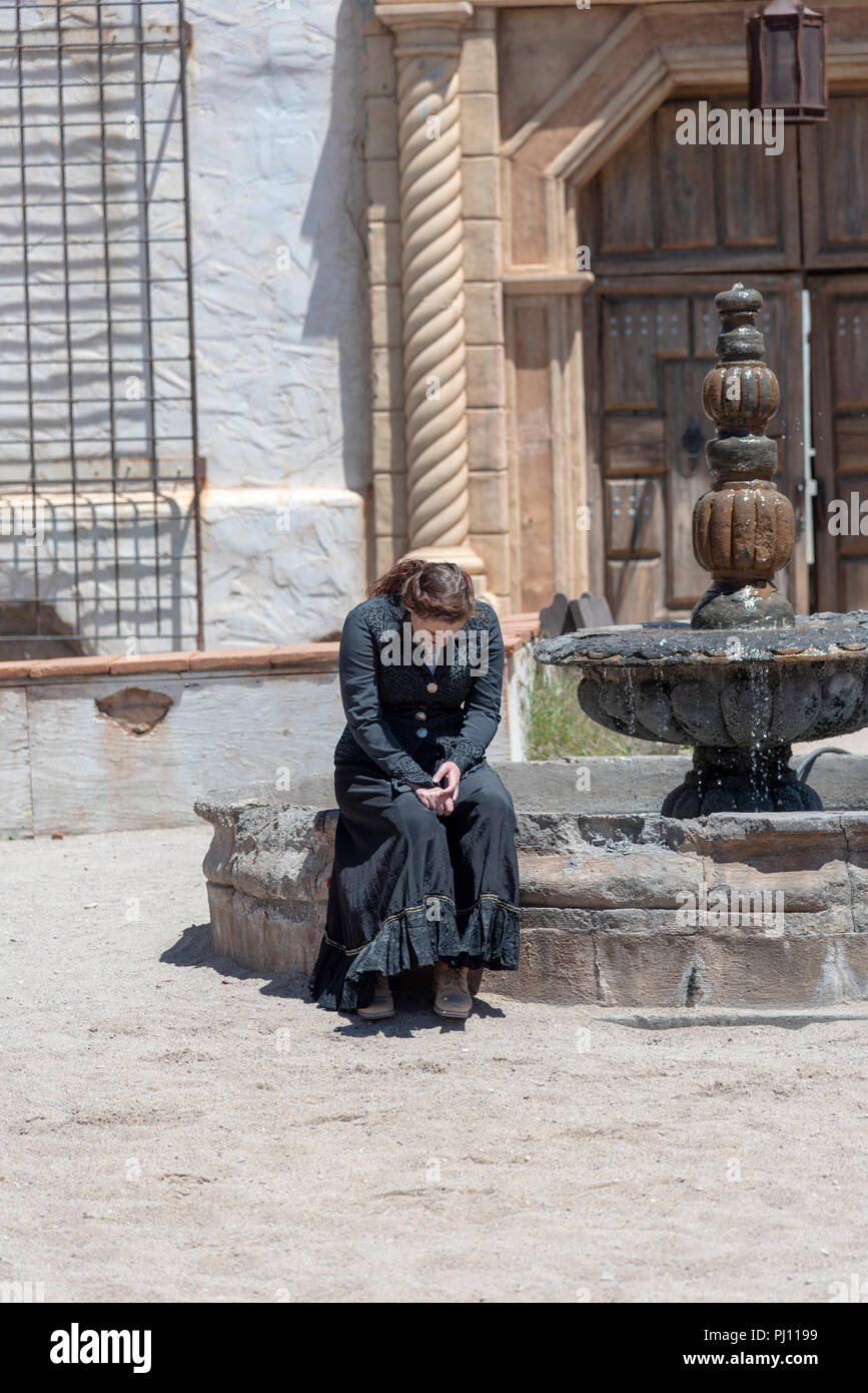 Actress weeping at the well in Old Tucson movie studios Stock Photo - Alamy