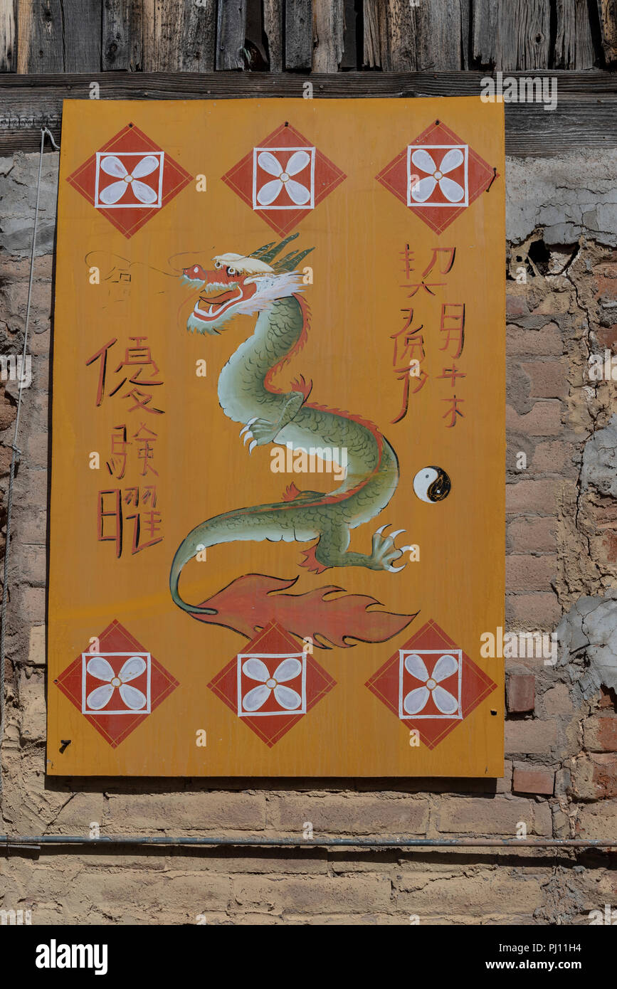 Sign with Chinese writing, symbols and dragon Stock Photo - Alamy