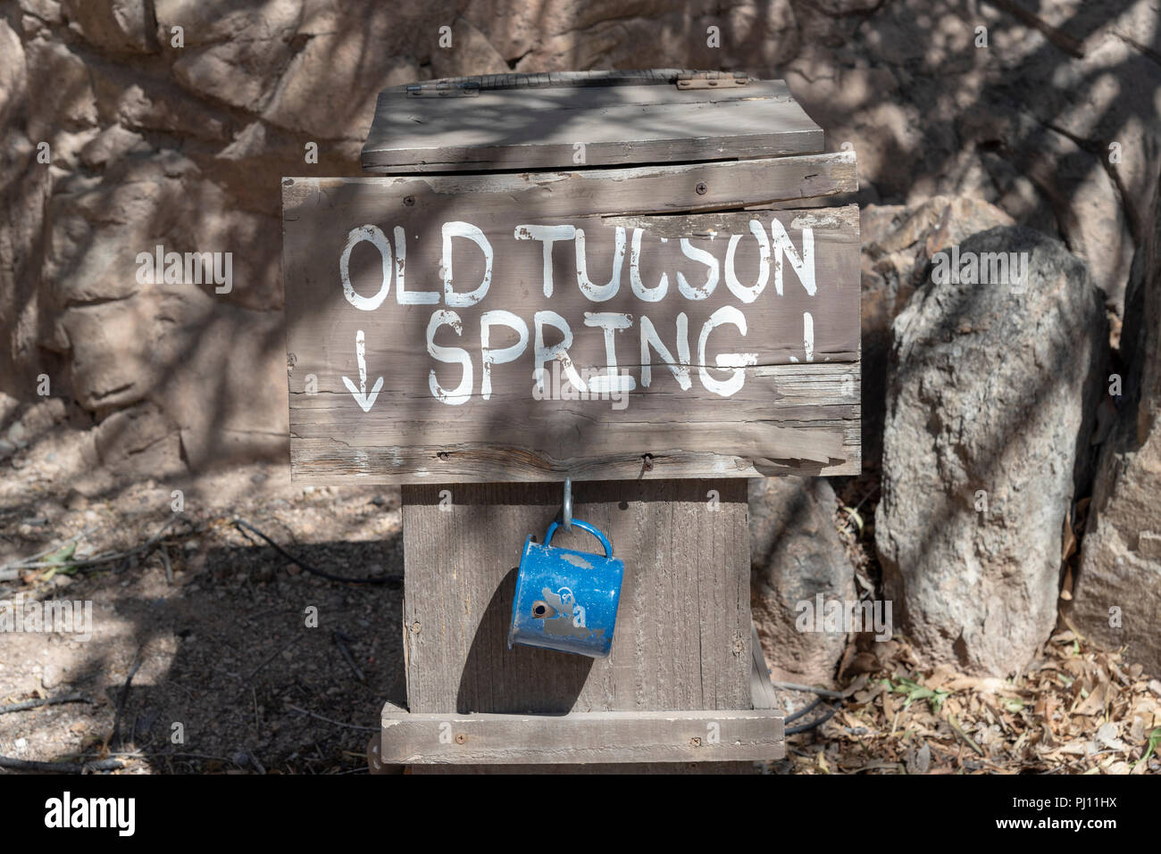 Sign, Old Tucson Spring with blue metal cup hanging on hook Stock Photo ...