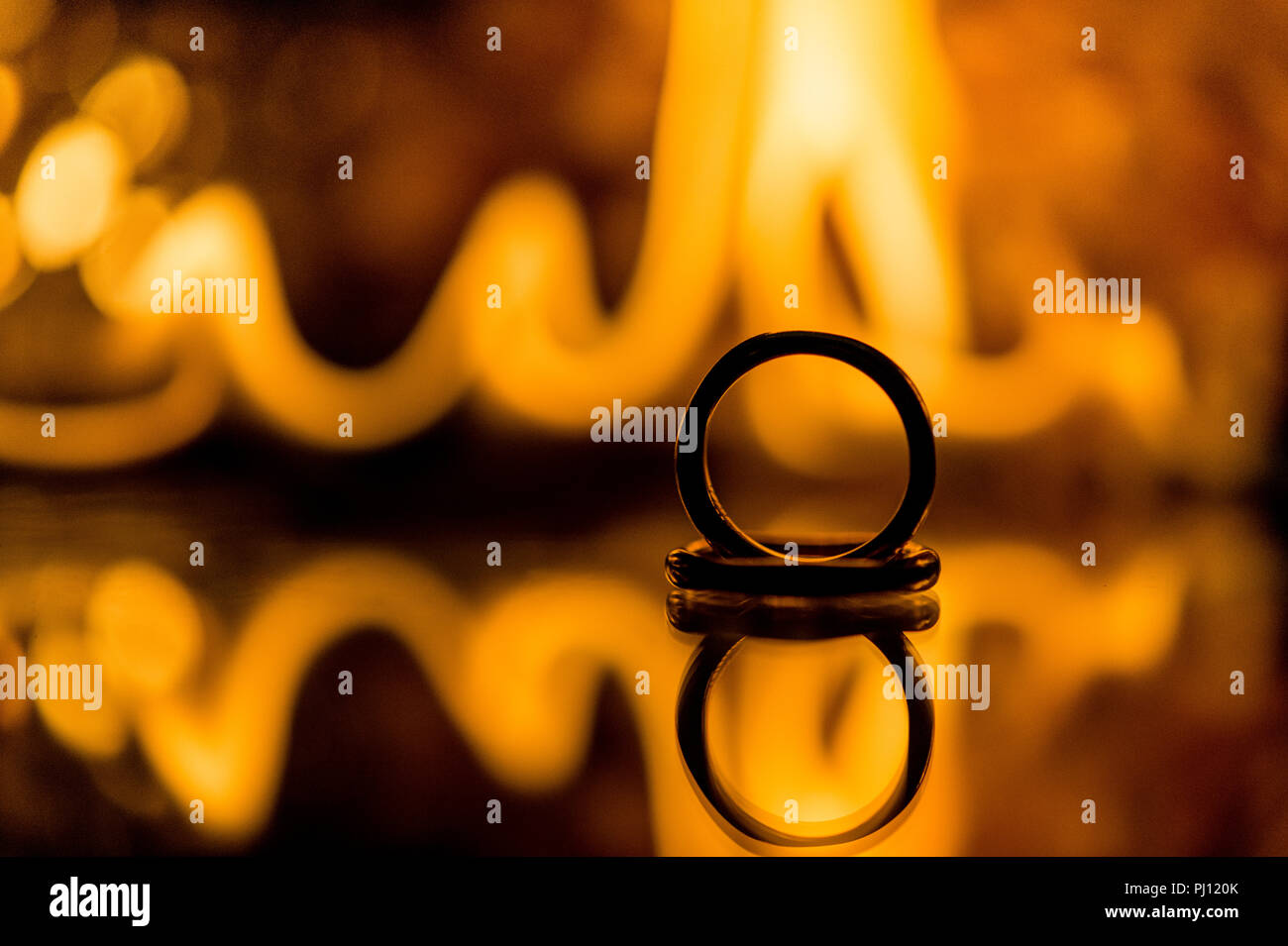 Wedding rings with fire background Stock Photo - Alamy