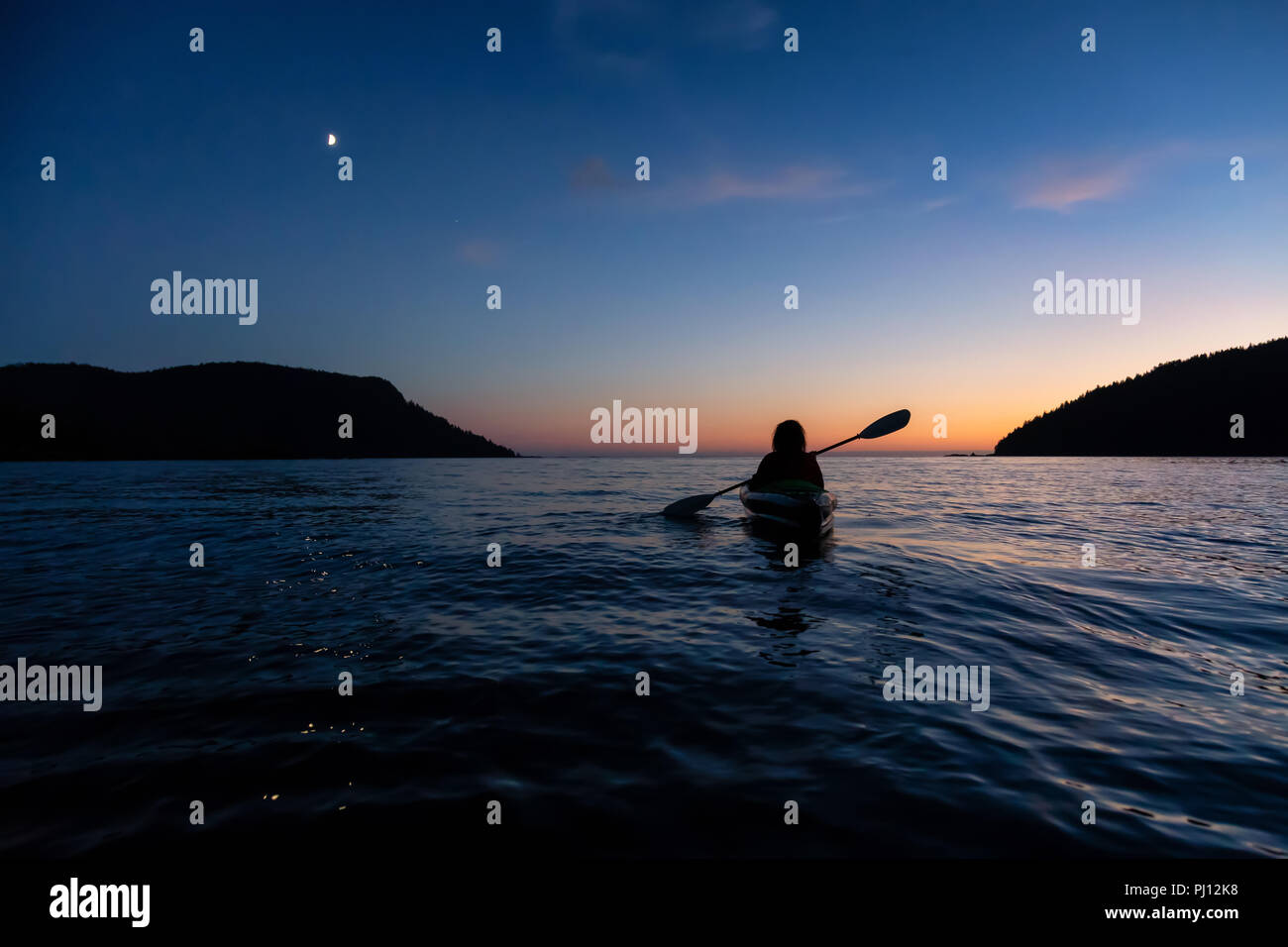 Sea Kayaking in the Pacific Ocean during twilight after summer sunset ...
