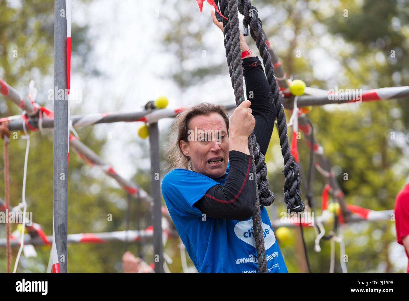 OLDENZAAL, NETHERLANDS - MAY 7, 2017: Unknown athlete hanging on a rope ...