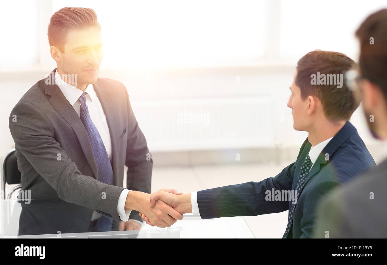 Businessmen making handshake in an office Stock Photo - Alamy
