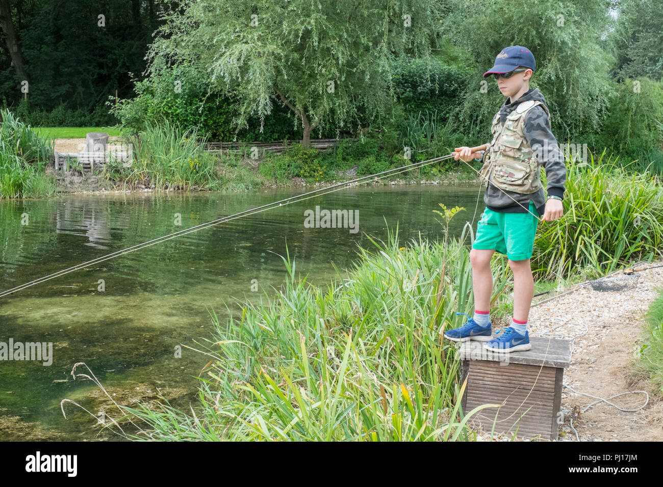Nine year old boy trout fishing at Church Paddock Trout Fishery ...