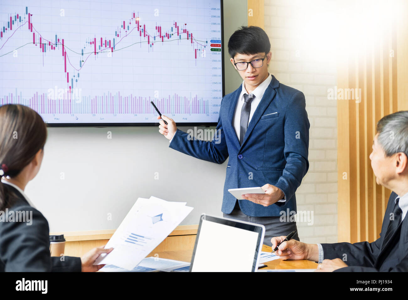 Business man speaker giving a talk stock profit graph presentation ...