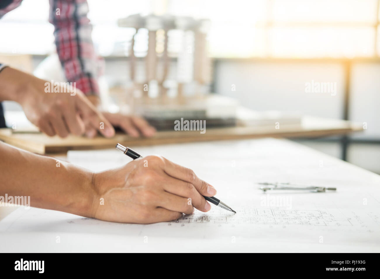 Close-up Of Person's engineer Hand Drawing Plan On Blue Print with ...