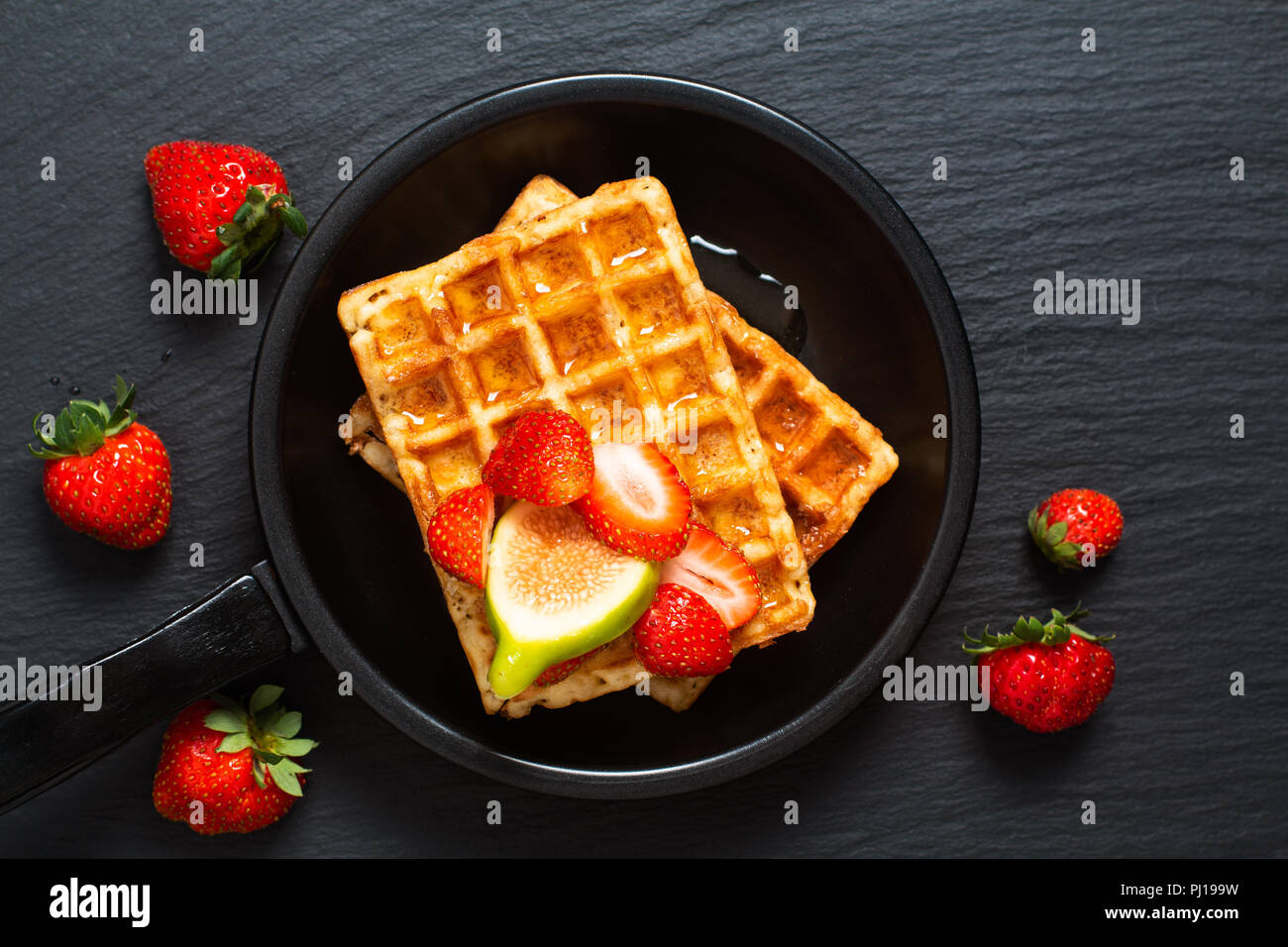 Food concept square Waffles and syrup with strawberry and fig topping ...