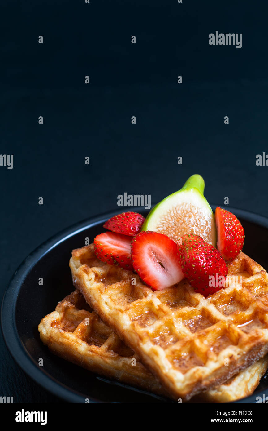 Food concept square Waffles and syrup with strawberry and fig topping ...