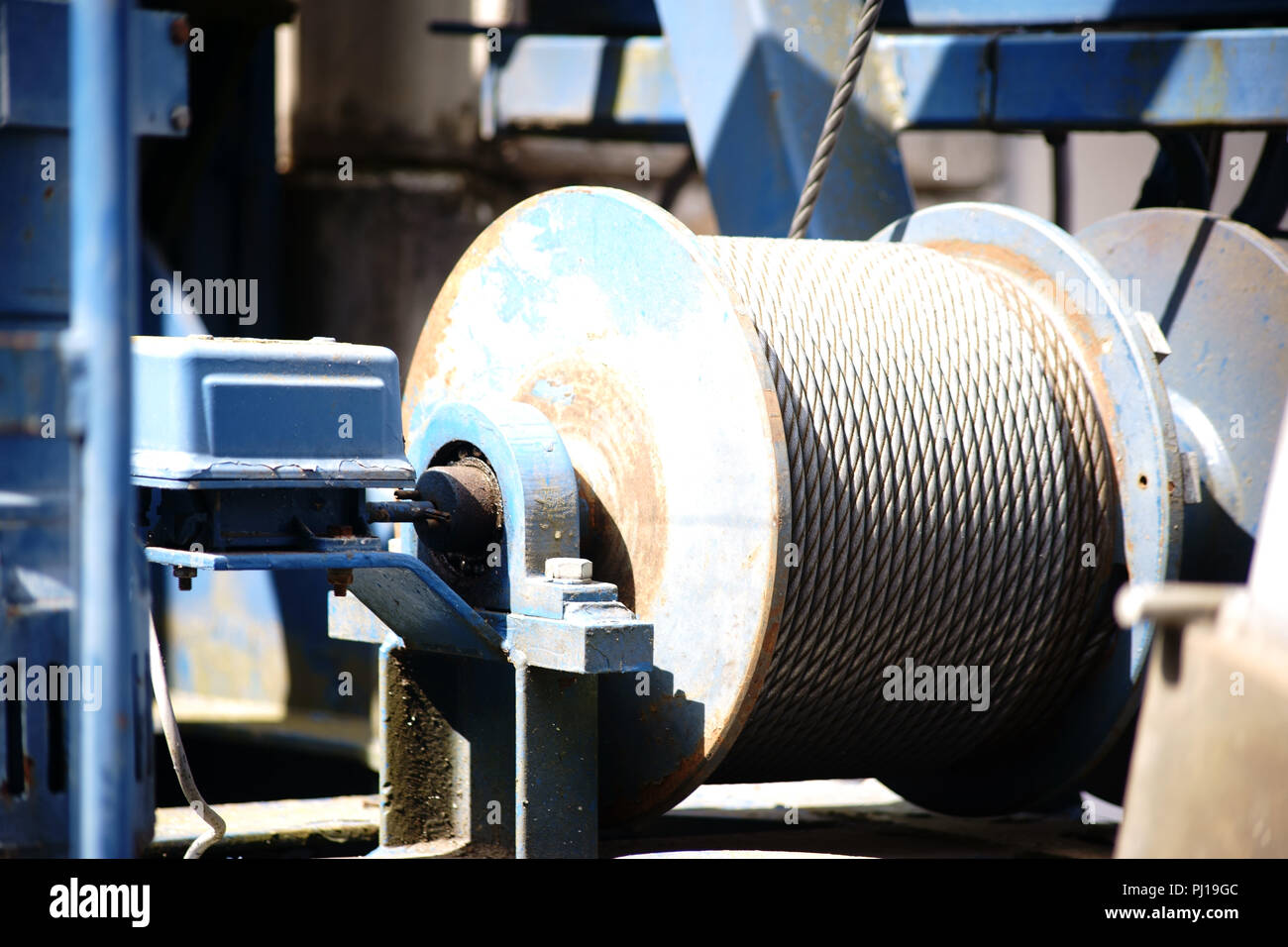 The close-up of the winch of a crane with a coiled steel rope Stock ...