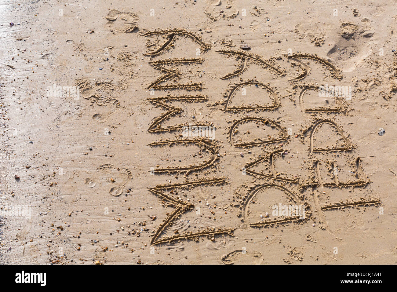 Mummy daddy teddy written in the sand hi-res stock photography and ...