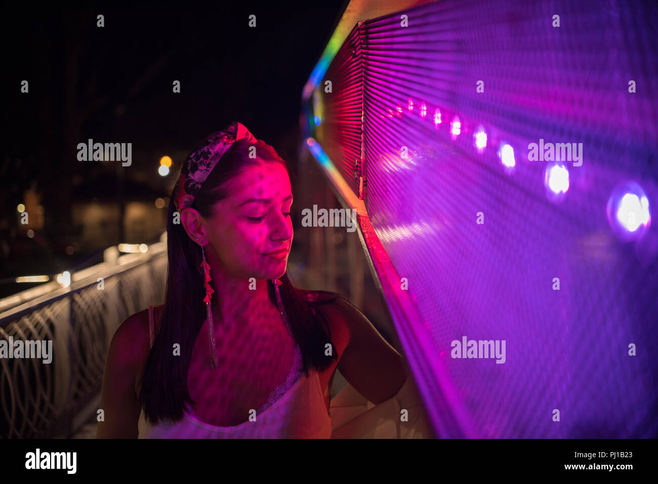 Woman standing in street by neon lights, Bosnia and Herzegovina Stock ...