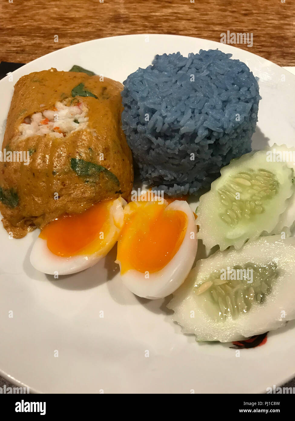 Thai blue rice with egg, cucumber and omelet wrap Stock Photo - Alamy