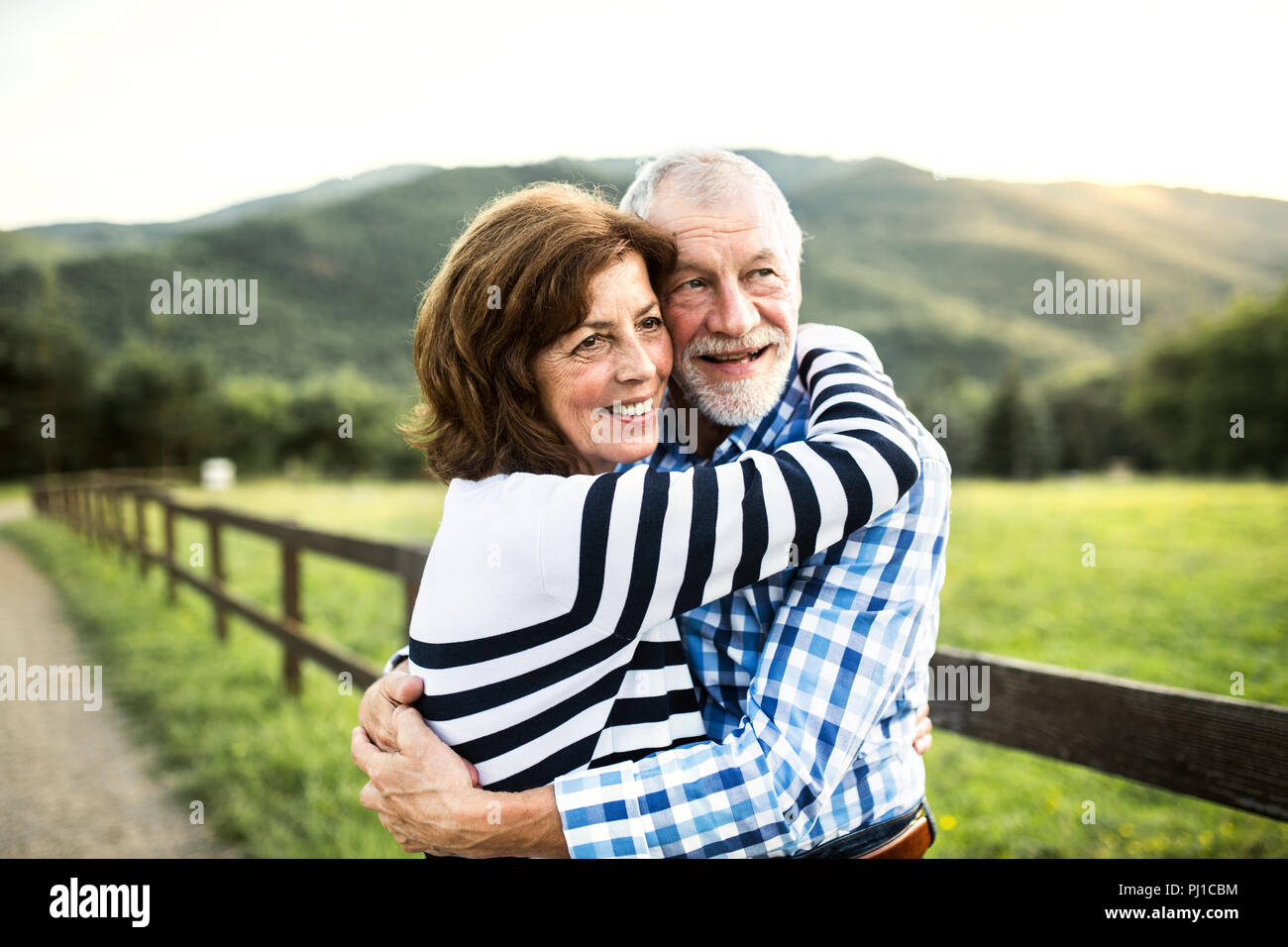A senior couple hugging outdoors in nature Stock Photo - Alamy