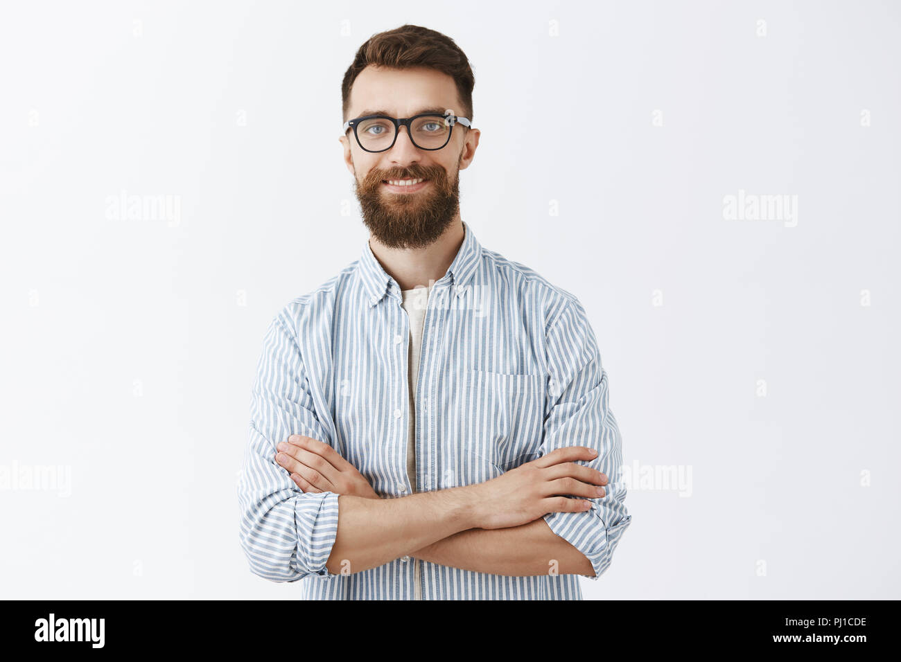 Confident smart and creative male entrepreneur in stylish striped ...