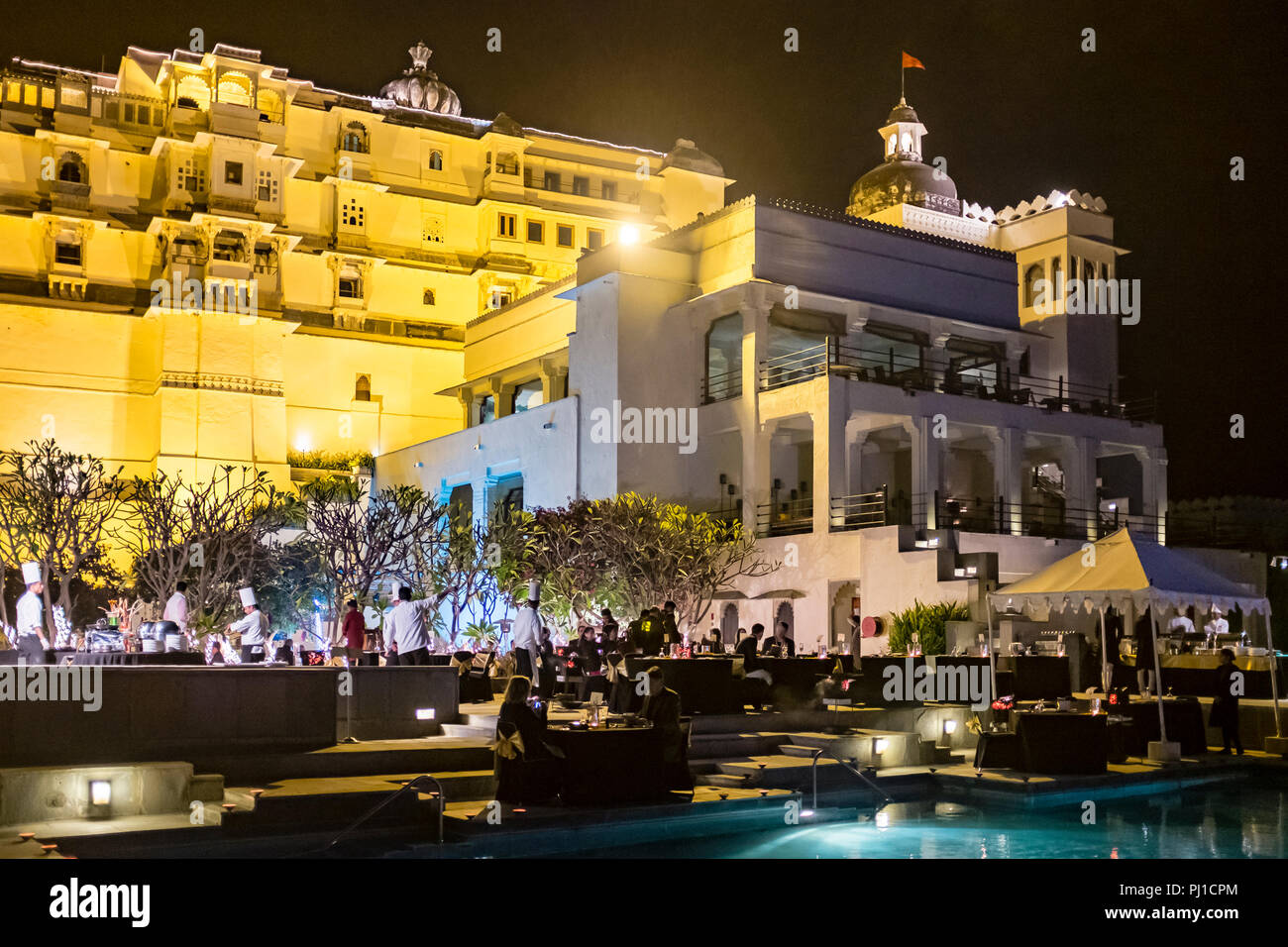 Outdoor dining by the pool at night at the RAAS Devigarh boutique hotel ...