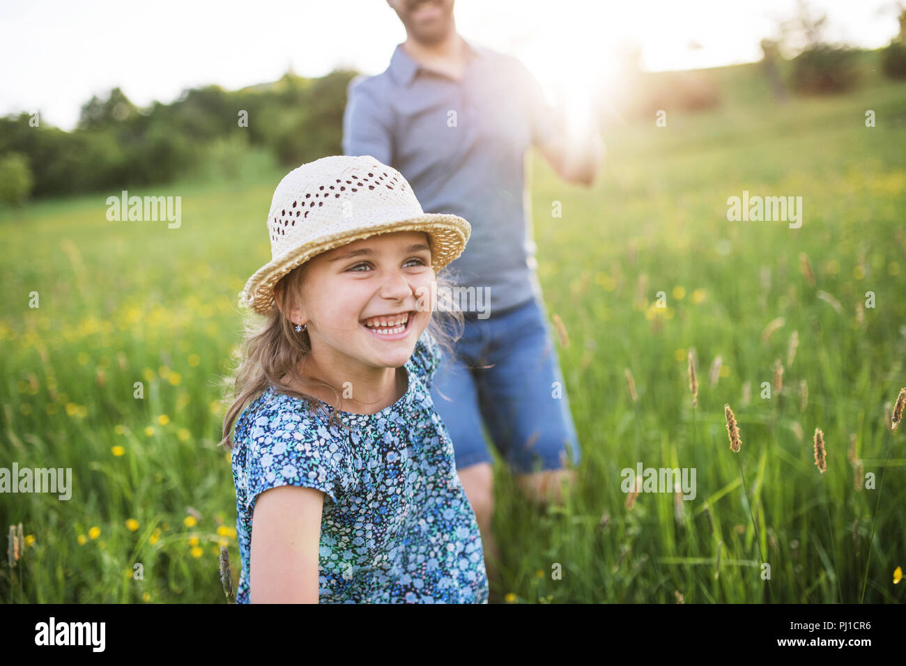 Father with a small daughter running in spring nature Stock Photo - Alamy