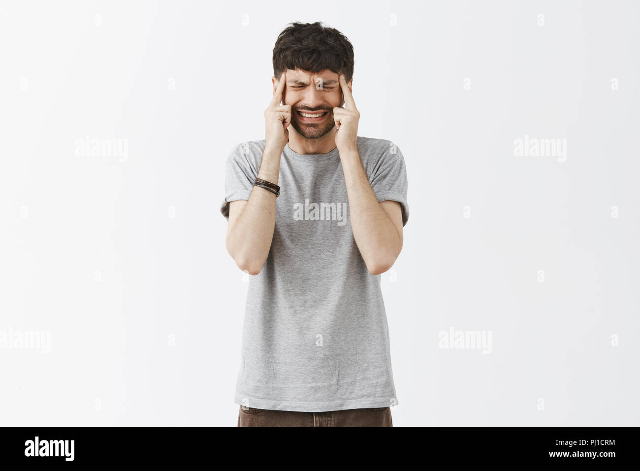 Man closing eyes clenching teeth hi-res stock photography and images ...