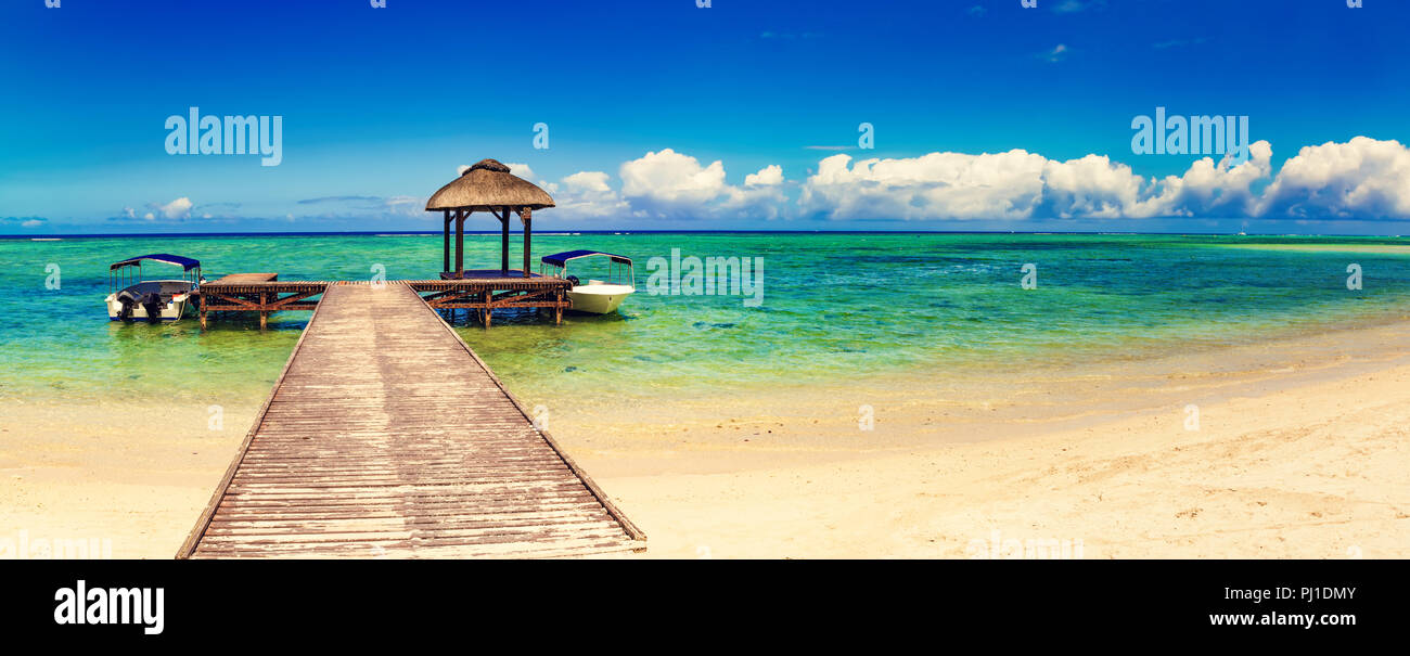 Sandy tropical Wolmar beach at sunny day. Jetty on the foreground ...