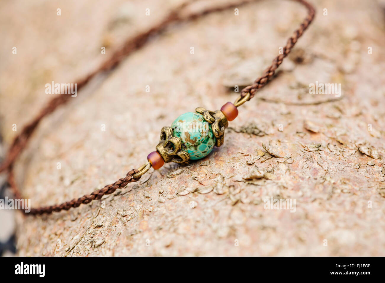 Natural stone bead bracelet on tiny waxed string Stock Photo - Alamy