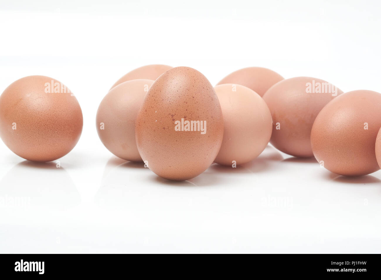 Many egg on the white scene Stock Photo - Alamy