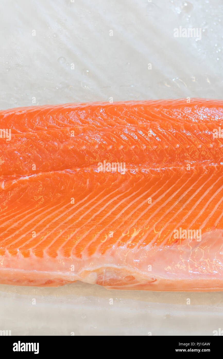 Salmon Fillet in Ice on the supermarket counter. Fillet of red fish in ...