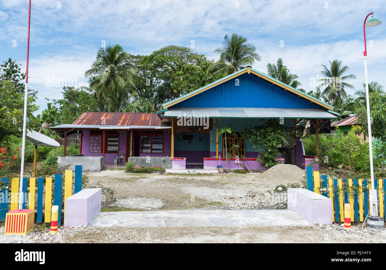 A colorfully painted house at settlement Nimbokrang, West Papua ...