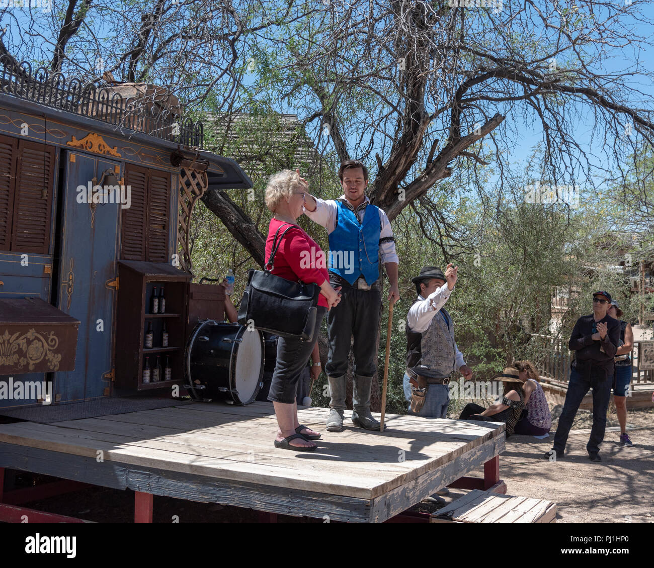 Tourists on stage with western actor Stock Photo - Alamy