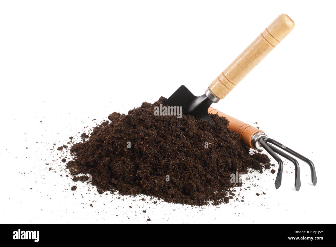 garden tools in soil isolated on white background Stock Photo - Alamy