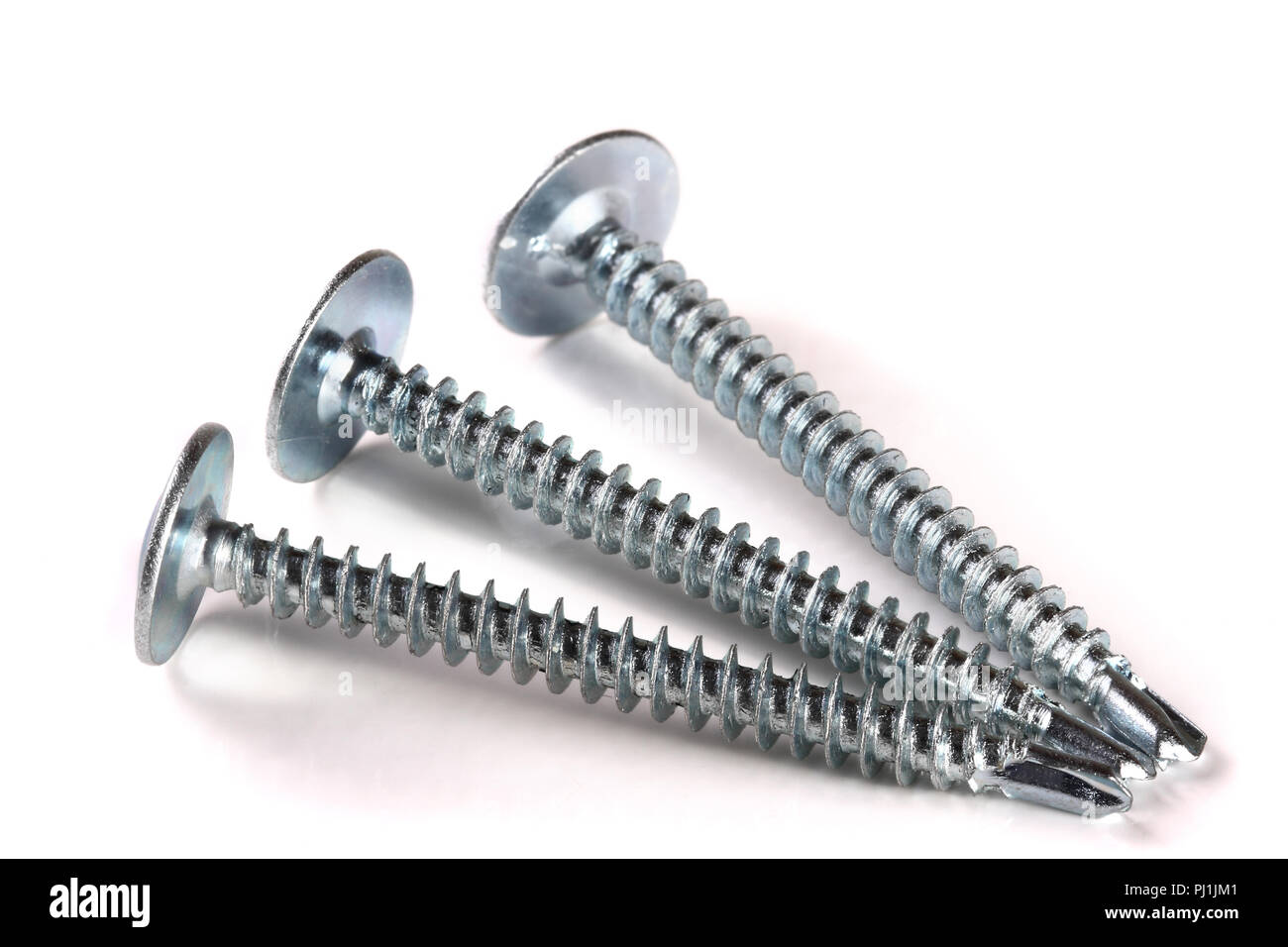 three metal screws isolated on white background closeup Stock Photo - Alamy